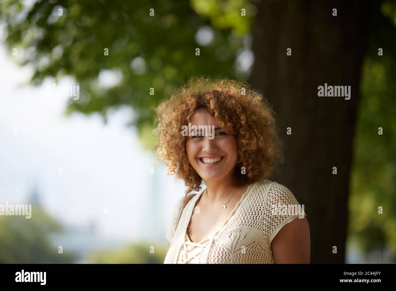 Portrait of smiling woman outdoors Stock Photo - Alamy