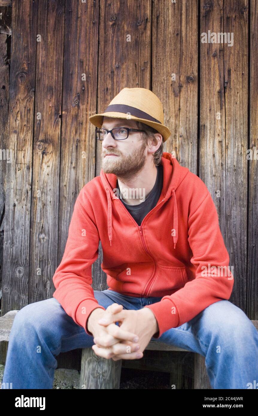 Man in front of a wooden hut Stock Photo - Alamy