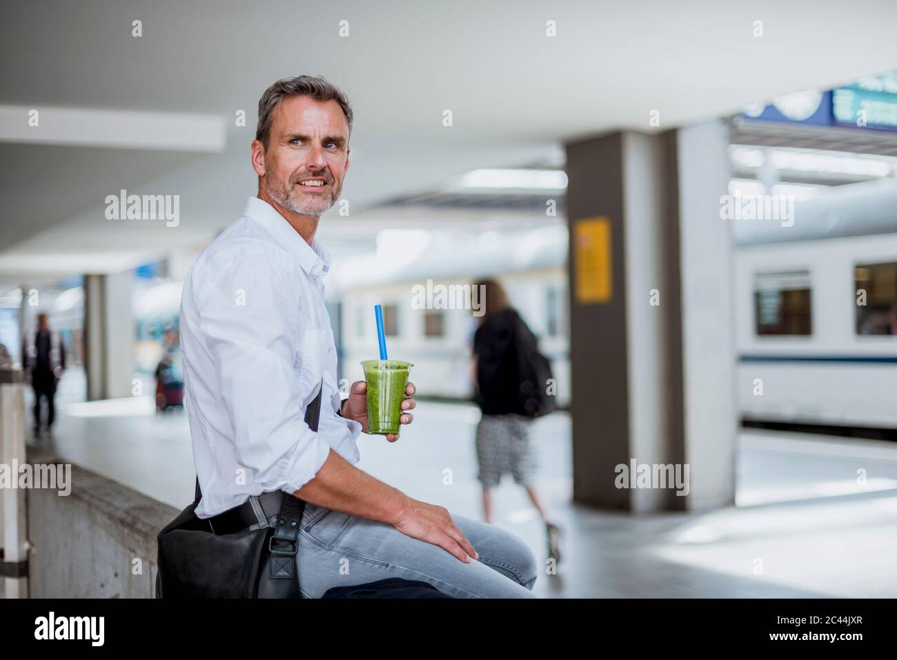 Sitting looking away holding food and drink hi-res stock photography ...