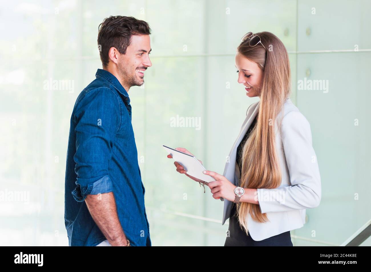 Two business people with digital tablet Stock Photo - Alamy