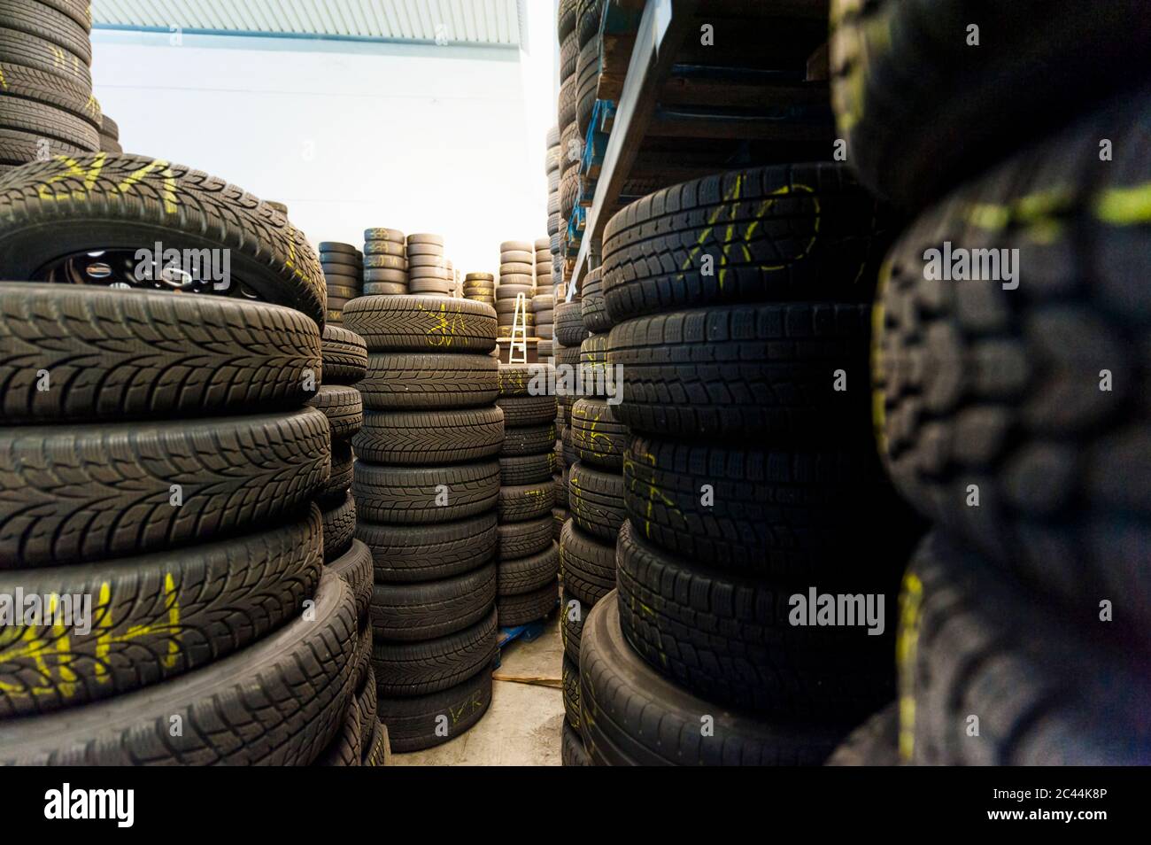 Close-up of rubber tire stacks at illuminated store Stock Photo - Alamy