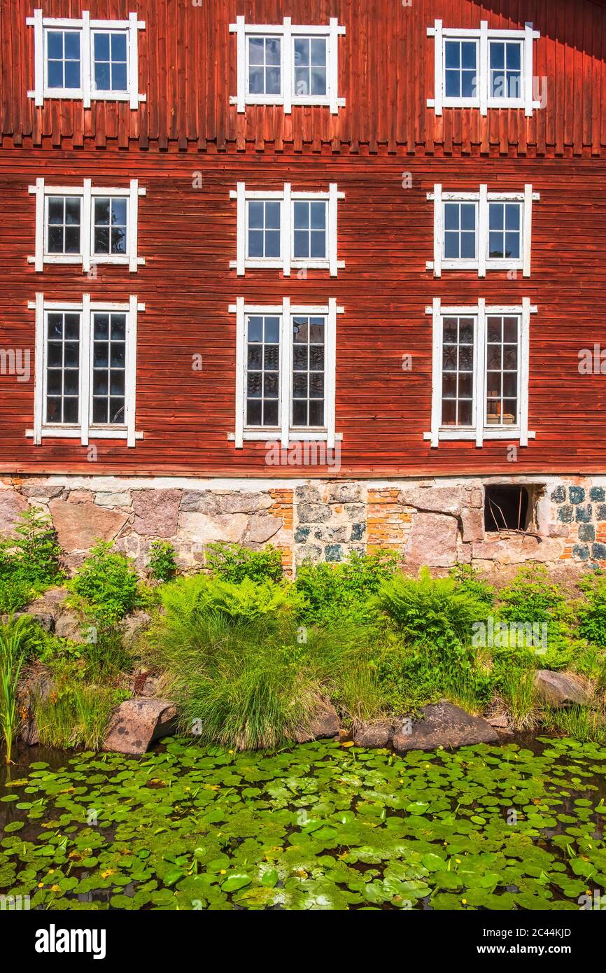 Beautiful red wooden building with windows Stock Photo - Alamy