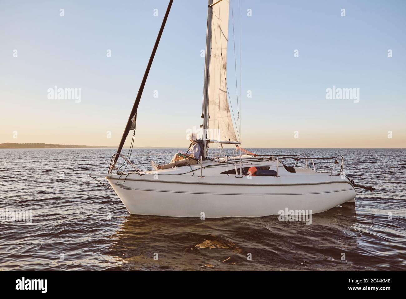 Luxury lifestyle. View of the sail boat or yacht floating in sea with ...