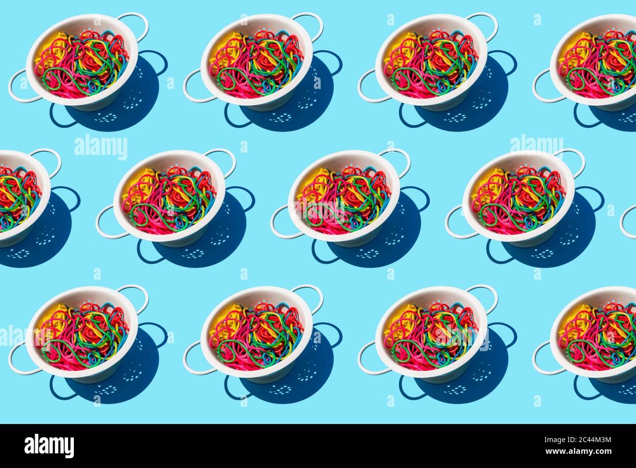 Pattern of colanders with colorful pasta Stock Photo - Alamy