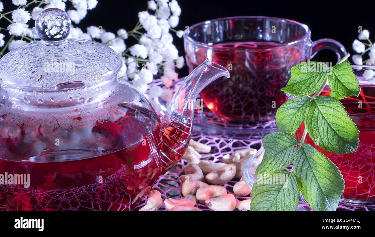 Creative layout made of cup of red tea and leafs. Tea time: cup of tea ...
