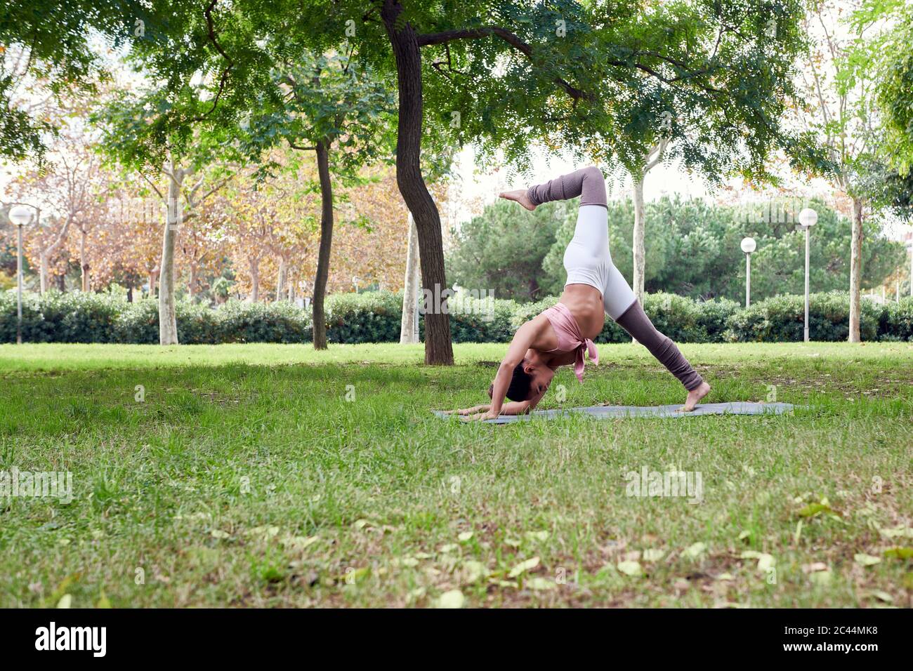 Woman practising yoga in park hi-res stock photography and images - Alamy