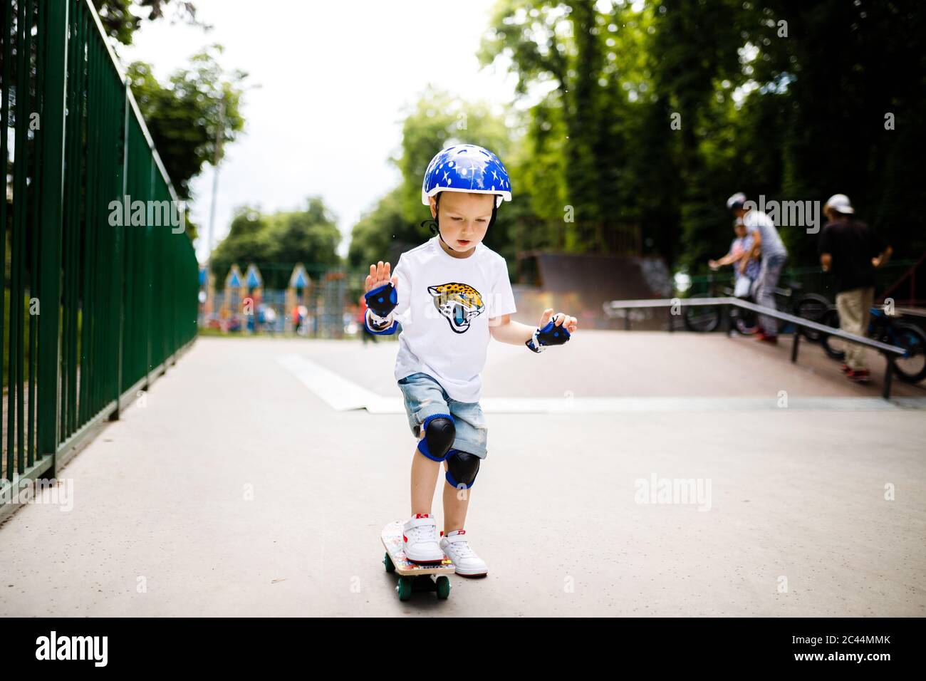 Boy with a skate in a skate park. The boy learns to skate, in full ...