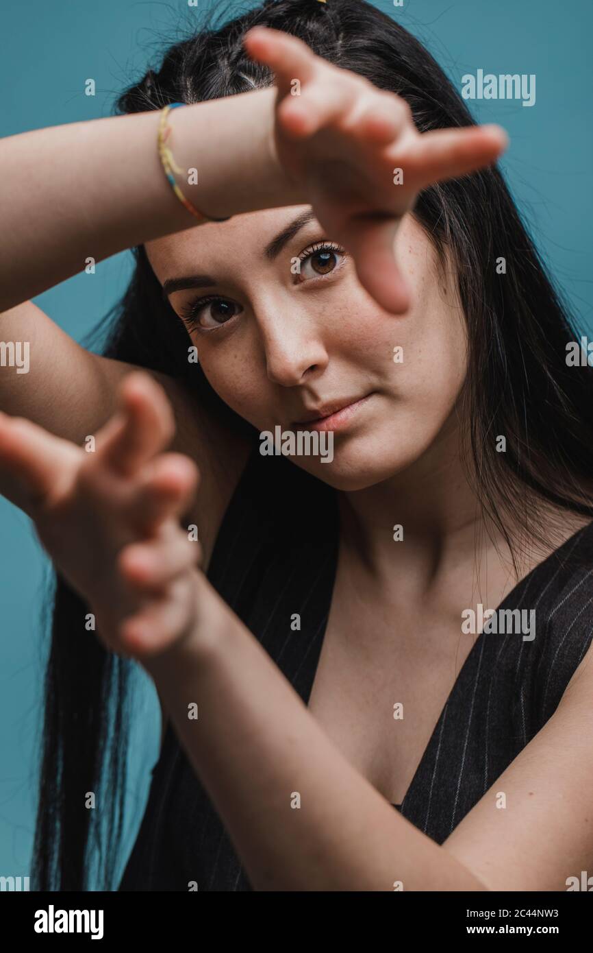 Beautiful woman moving hands in front of green background Stock Photo ...