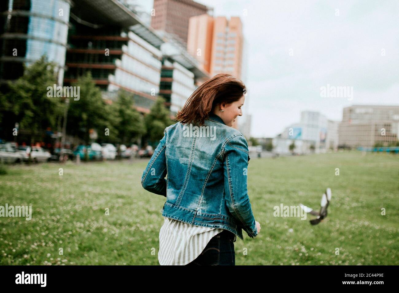 Rear view young woman wearing denim jacket hi-res stock photography and ...