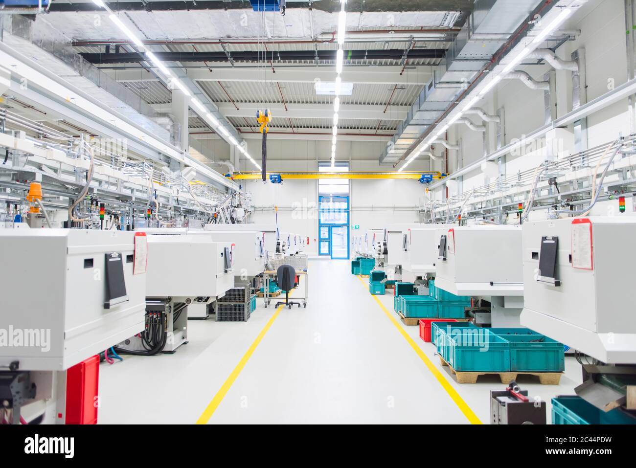 Machinery in empty factory shop floor Stock Photo - Alamy
