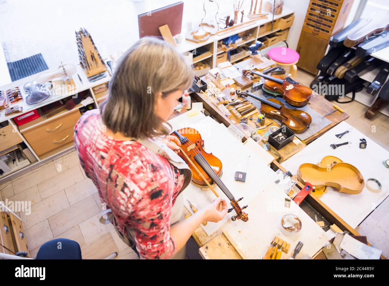 Female violin maker at work in her workshop Stock Photo - Alamy