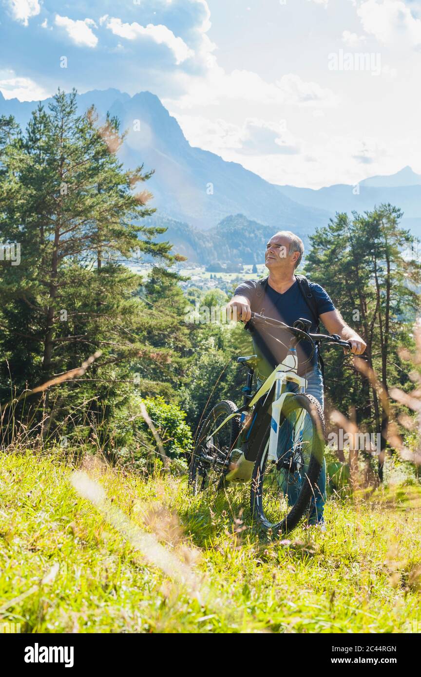 Senior man with e-bike Stock Photo - Alamy