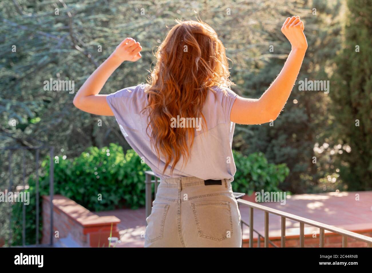 Woman arms raised rear view hi-res stock photography and images - Alamy