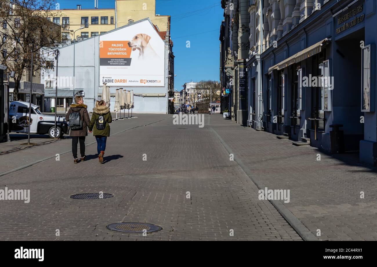 Young couple walking at the empty Old Town's streets in Coronavirus ...