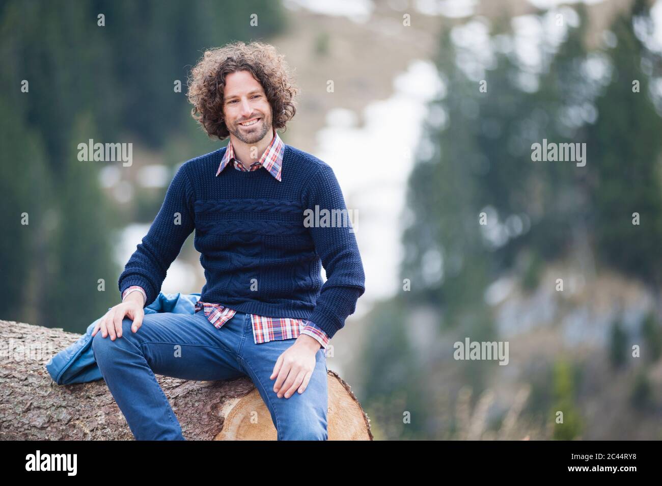 Man sitting on log on hi-res stock photography and images - Alamy