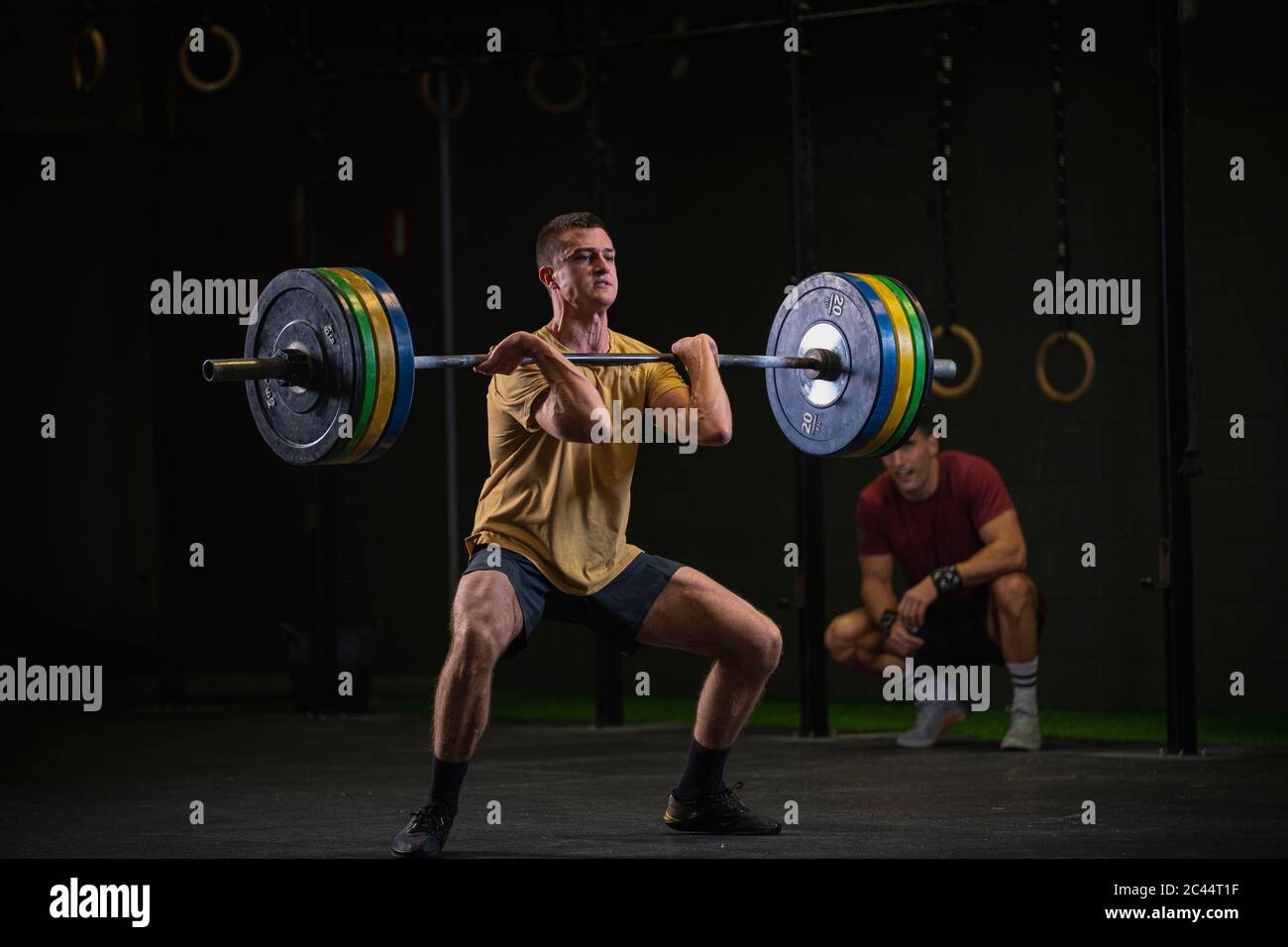 Man doing overhead squat exercise at gym Stock Photo - Alamy
