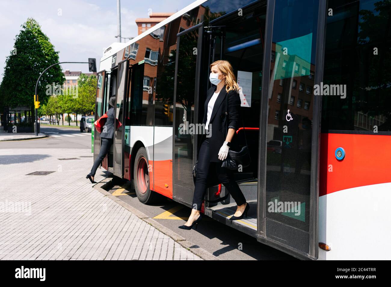 Woman getting off bus hi-res stock photography and images - Alamy