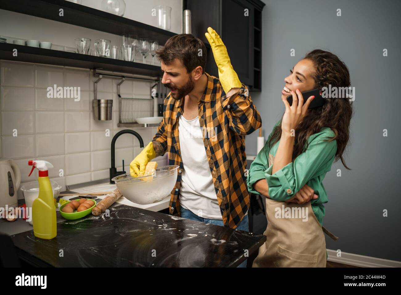 Young Multiethnic Couple Is Cleaning Their Kitchen Woman Is Lazy And