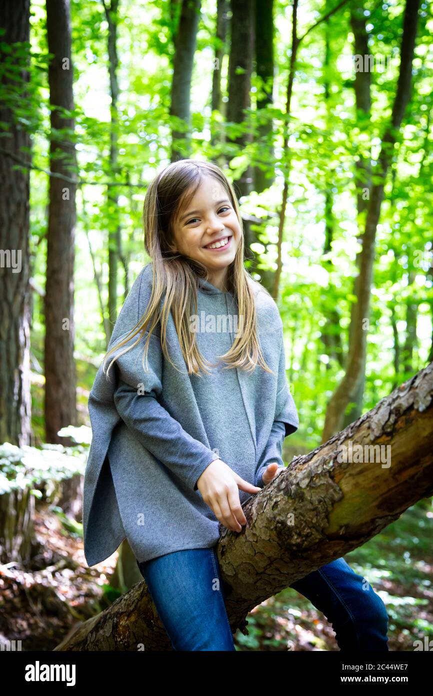 Girl sitting on tree hi-res stock photography and images - Alamy
