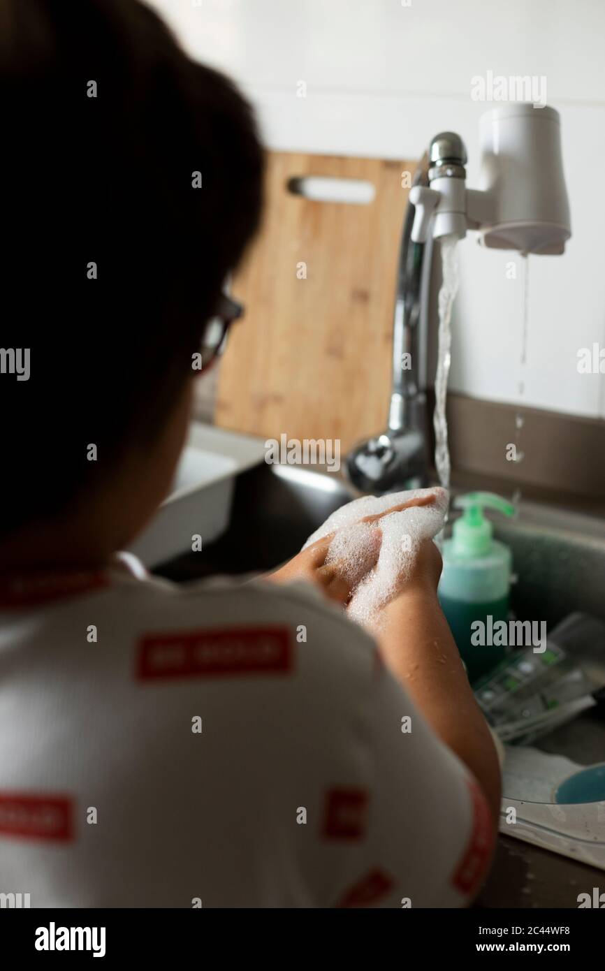 Boy washing dishes hi-res stock photography and images - Alamy