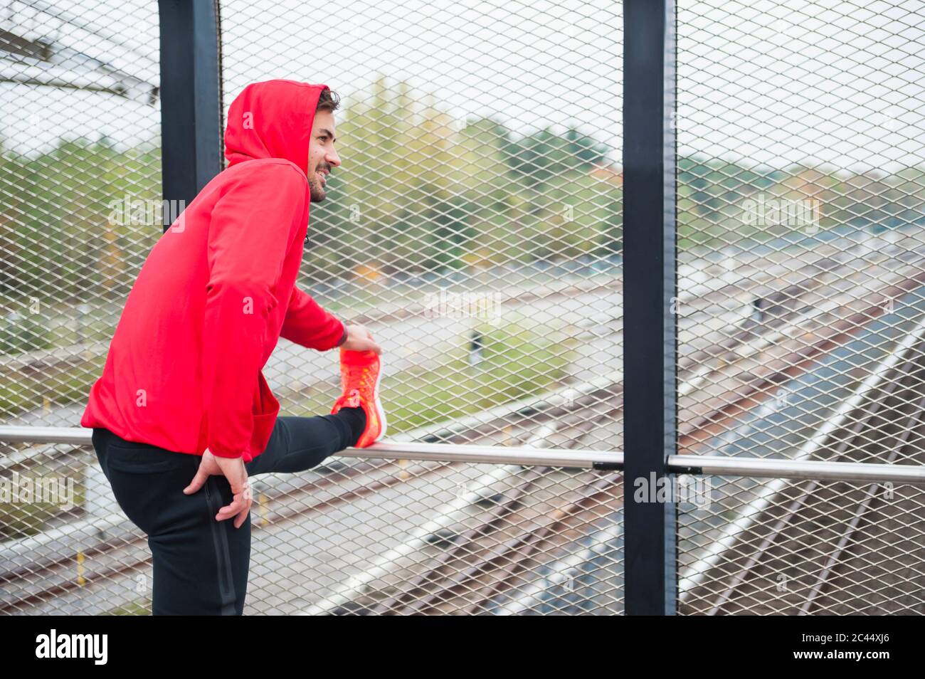 Stretching his leg on a bridge railing hi-res stock photography and ...