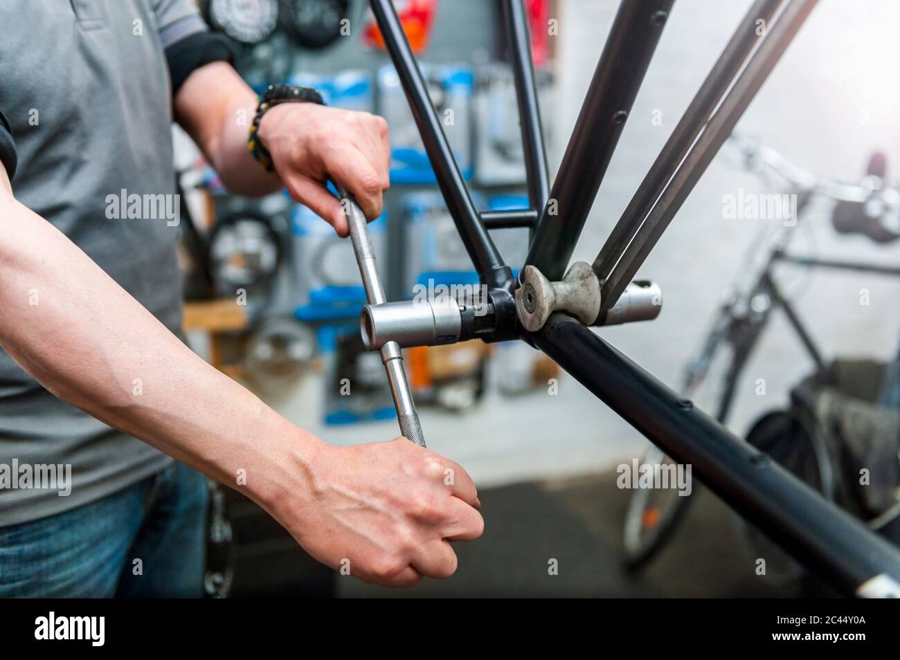 Bicycle mechanic working in bike shop Stock Photo - Alamy