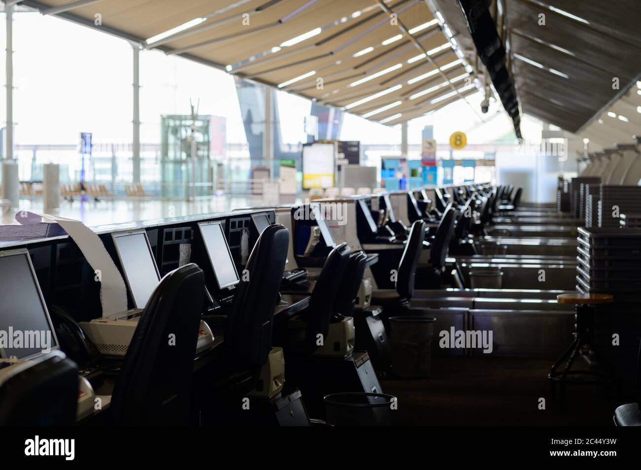 Row of empty check-in desks with computer monitors at the airport Stock ...