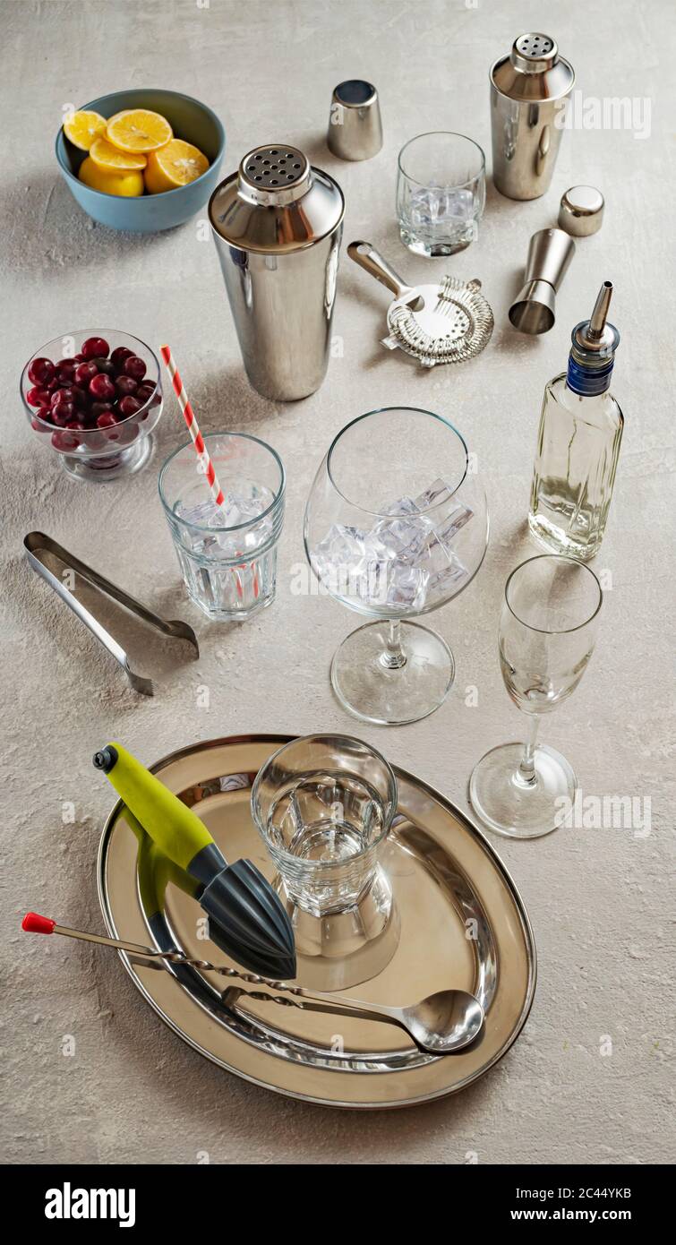 bar tools, Shaker and cocktail glasses, mixology tools on a white table ...