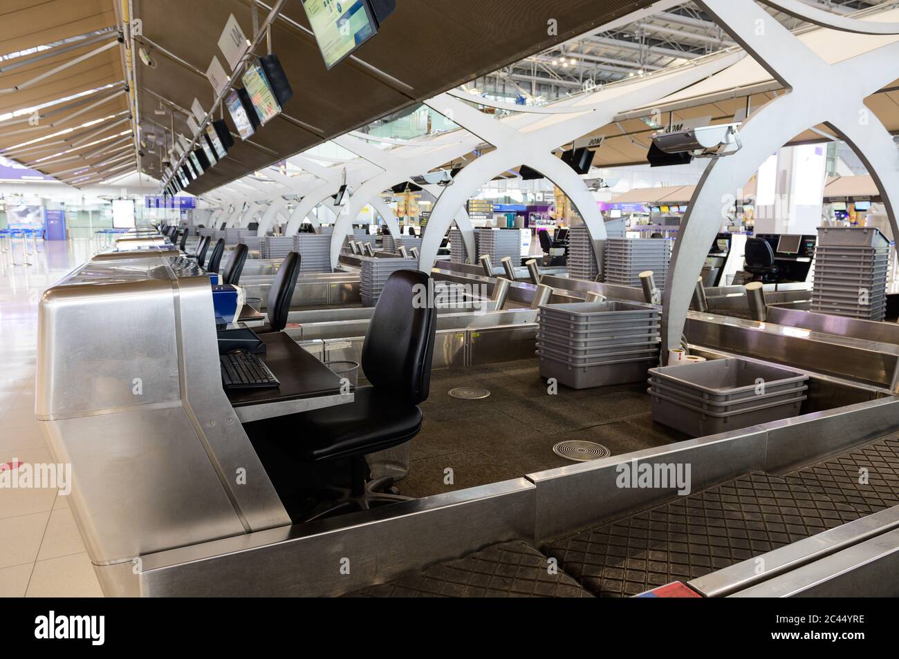 Row of empty check-in desks with luggage boxes at the airport Stock ...