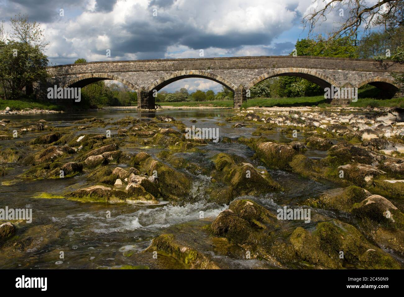 Large stone bridge crossing the river ribble near Clitheroe. Rocks and ...