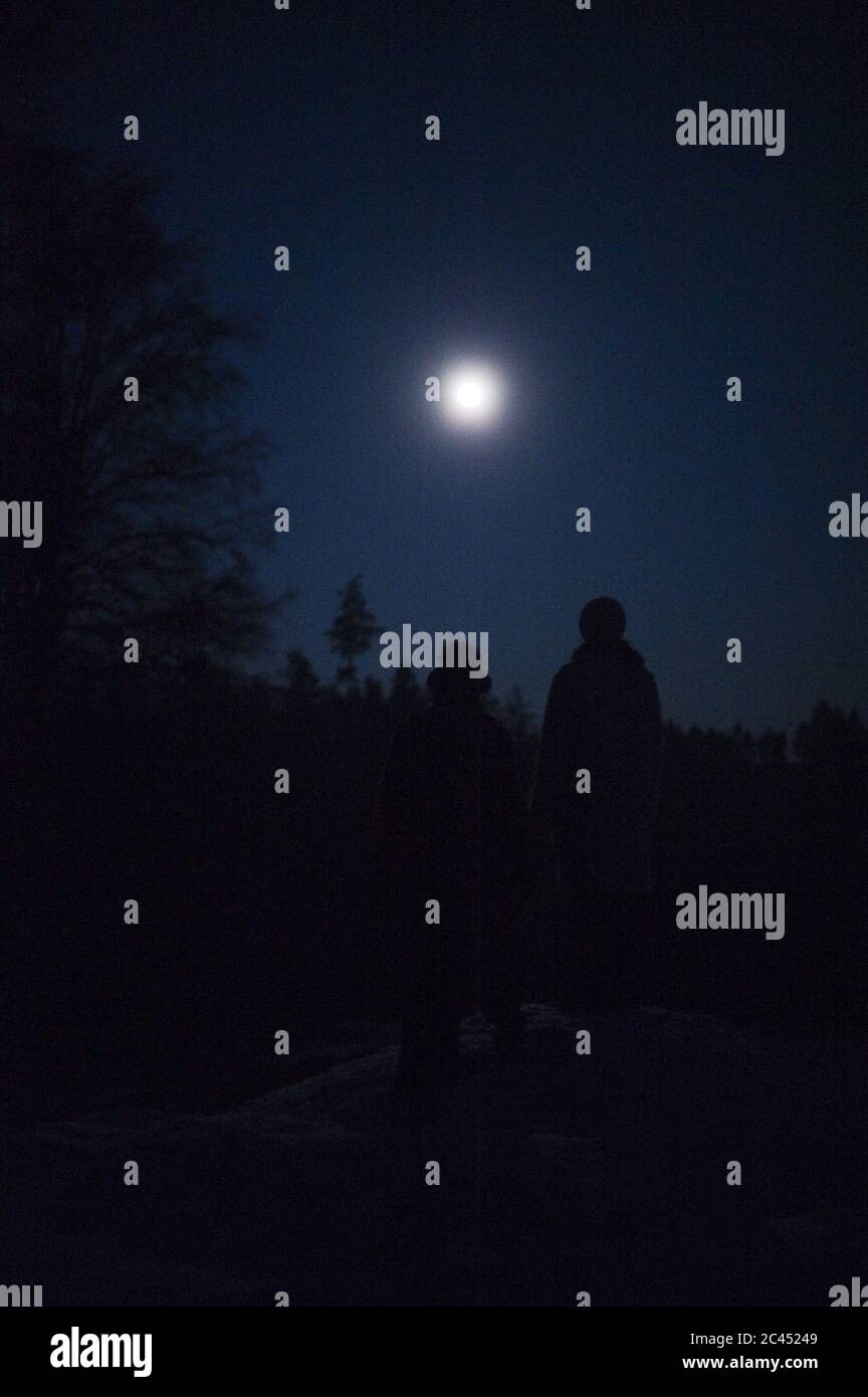 Two people by moonlight Stock Photo - Alamy