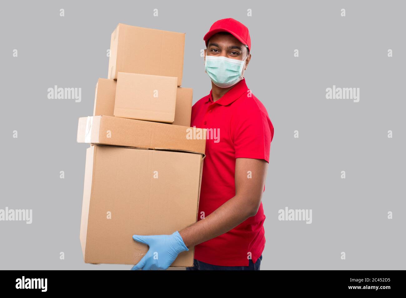 Delivery Man Holding a lot Carton Boxes Wearing Medical Mask and Gloves ...