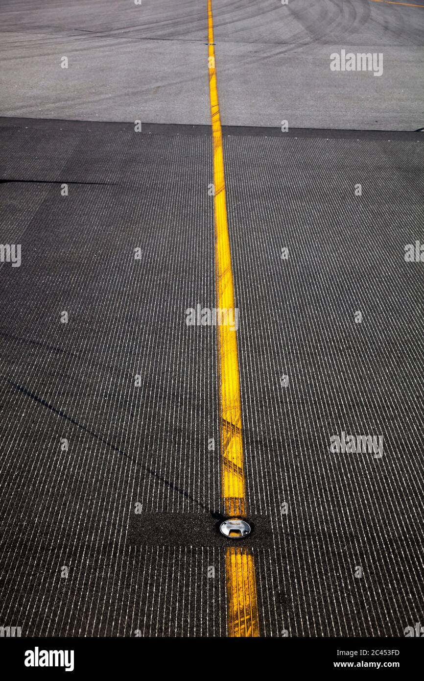 Yellow line on the runway of an airport Stock Photo - Alamy