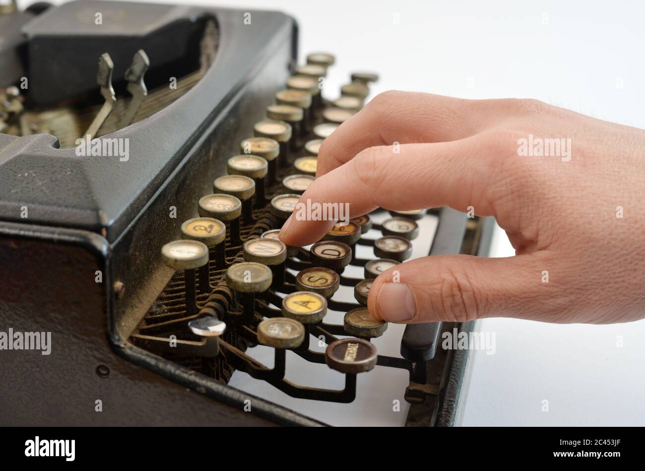 Hand typing on a vintage typewriter Stock Photo - Alamy