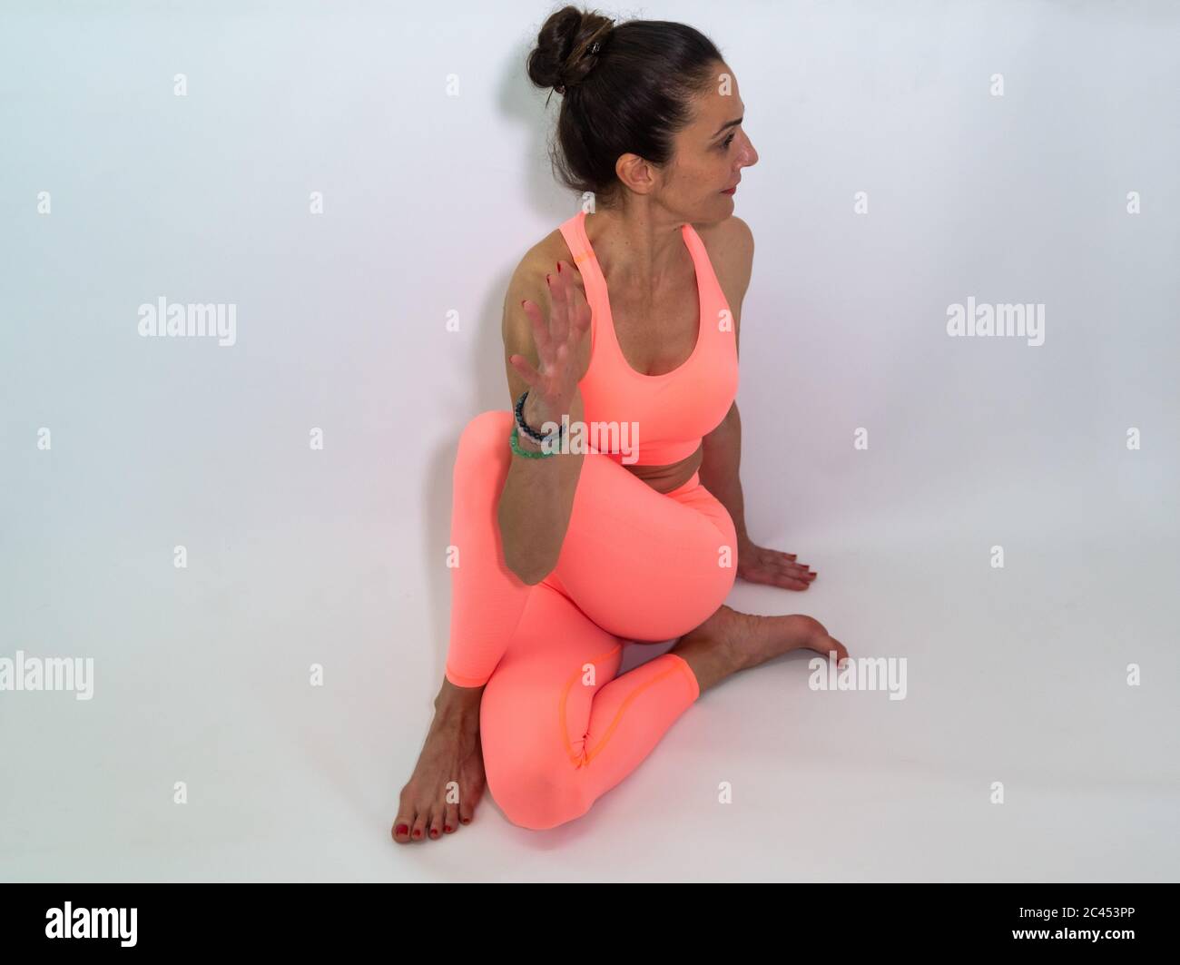 Young woman doing complex yoga exercises in the studio Stock Photo - Alamy