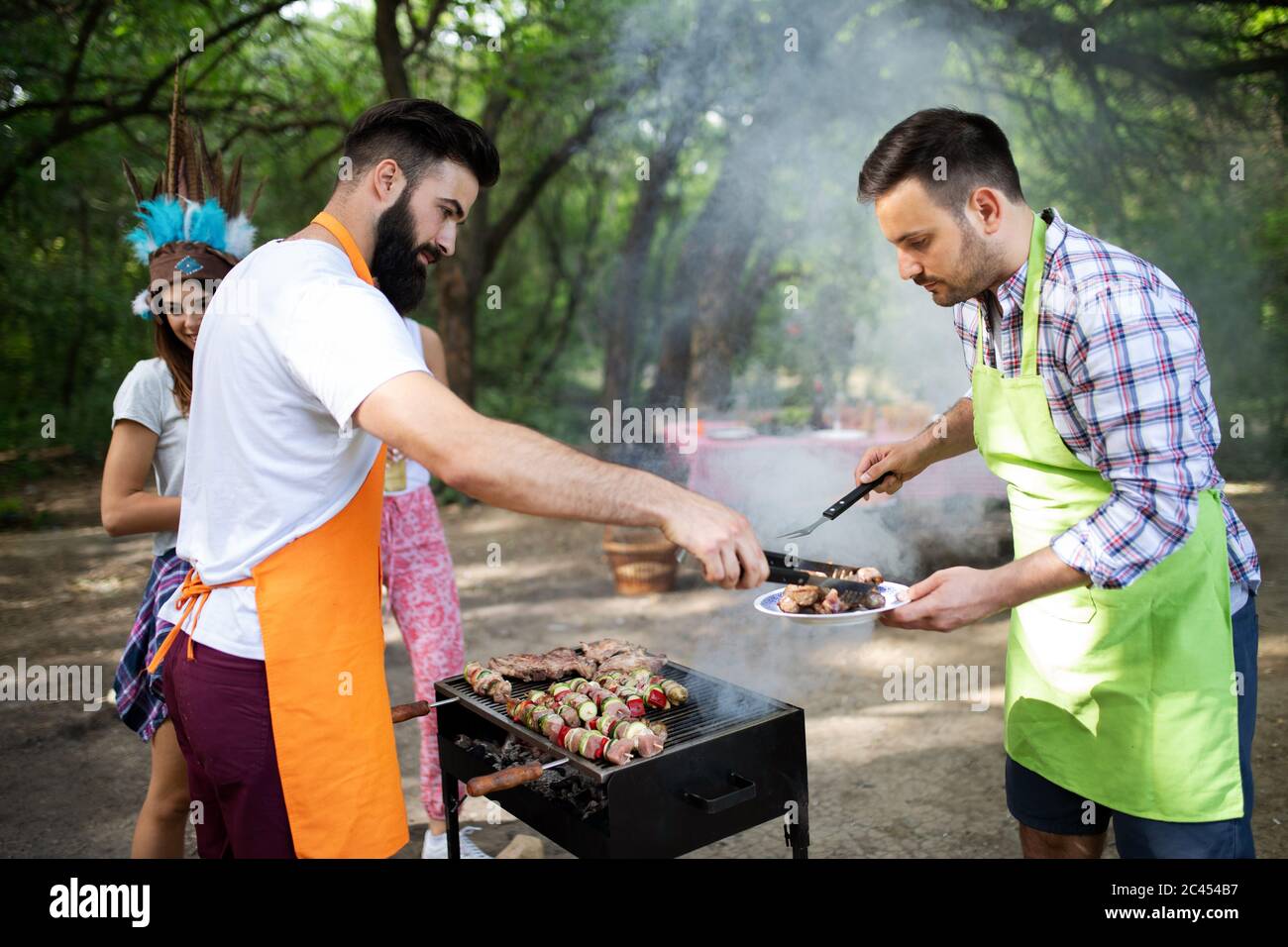 Friends having fun in nature doing bbq Stock Photo - Alamy