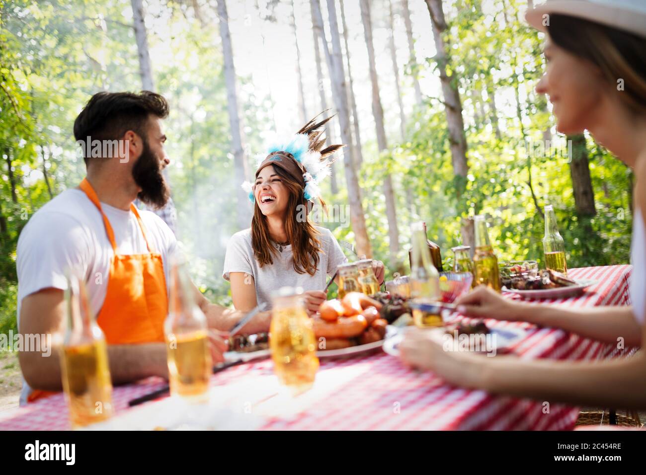Group of happy friends having outdoor barbecue party and fun together ...