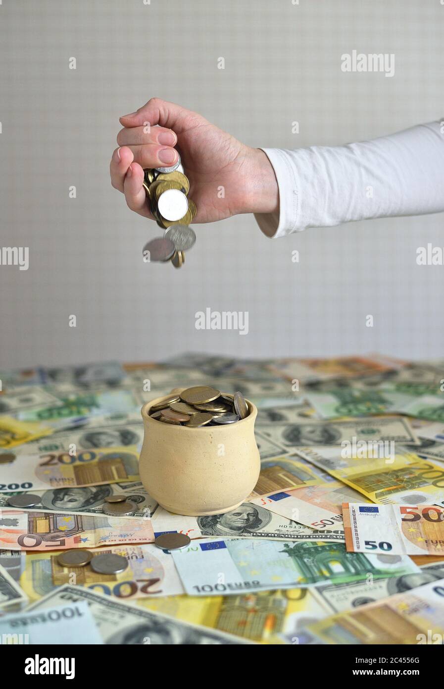 coins are falling in the cup. coins pour out of a female hand Stock ...