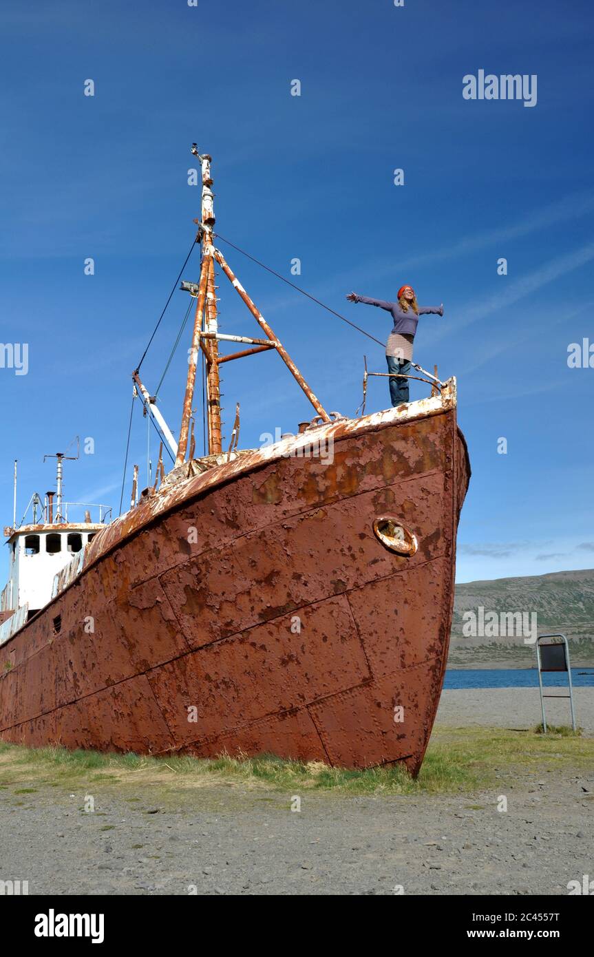 Woman on a shipwreck on the west coast of Iceland Stock Photo - Alamy
