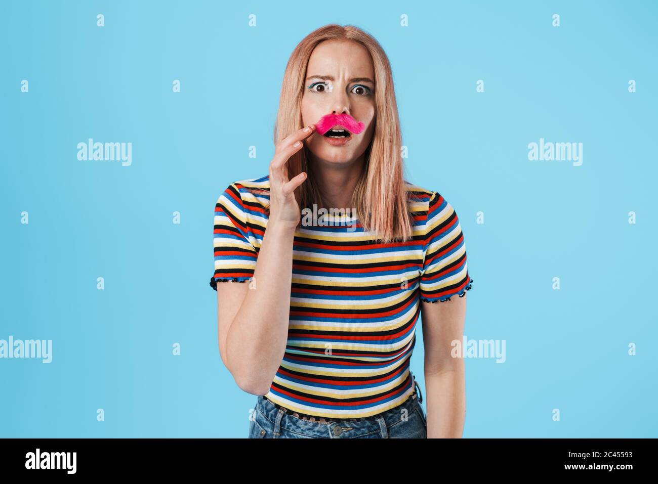 Image of amusing beautiful girl with fake mustaches and expressing ...