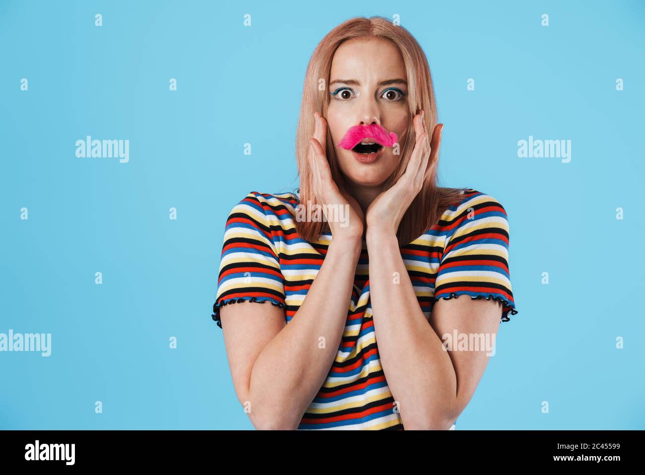Image of shocked beautiful girl with fake mustaches and expressing ...