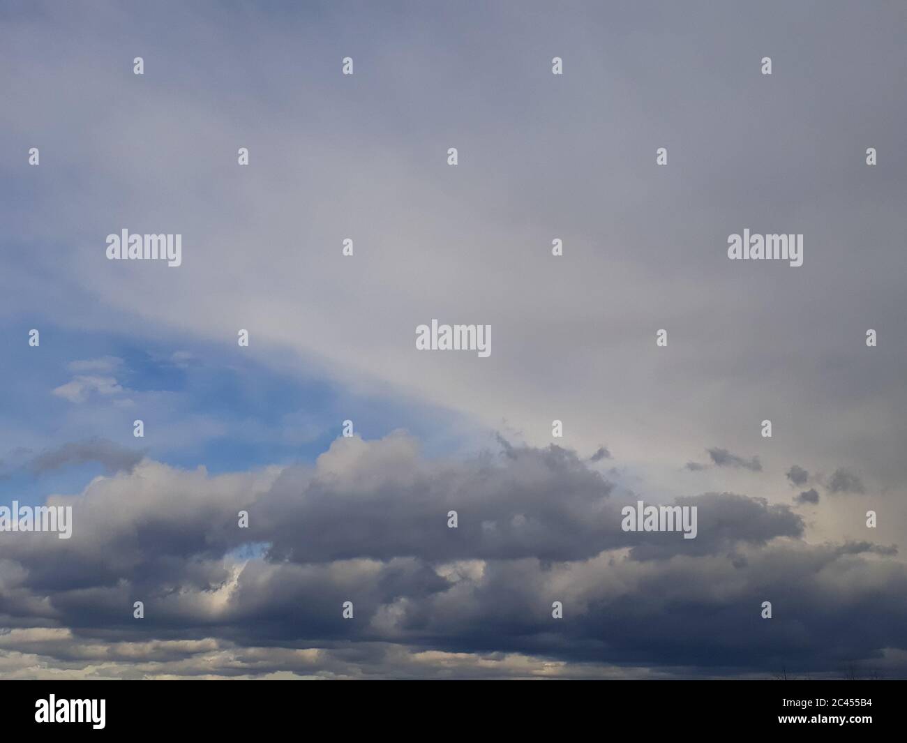 Heavy gray rain clouds in the blue sky. Atmosphere, air, cloudy, soon ...