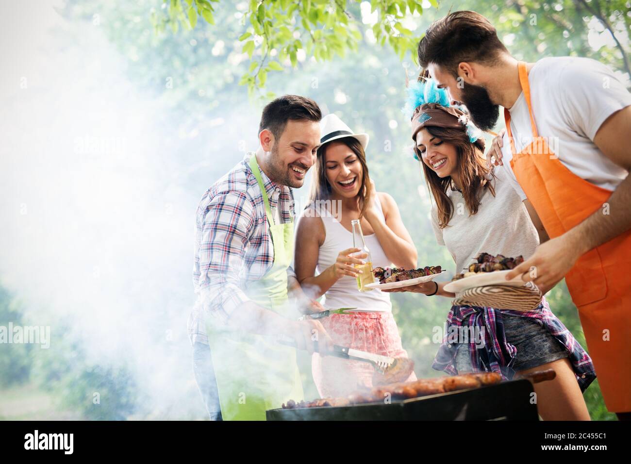 Friends having fun in nature doing bbq Stock Photo - Alamy