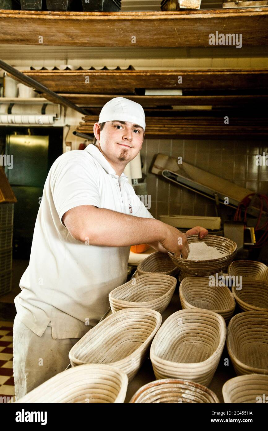 Baker works in a bakery Stock Photo - Alamy