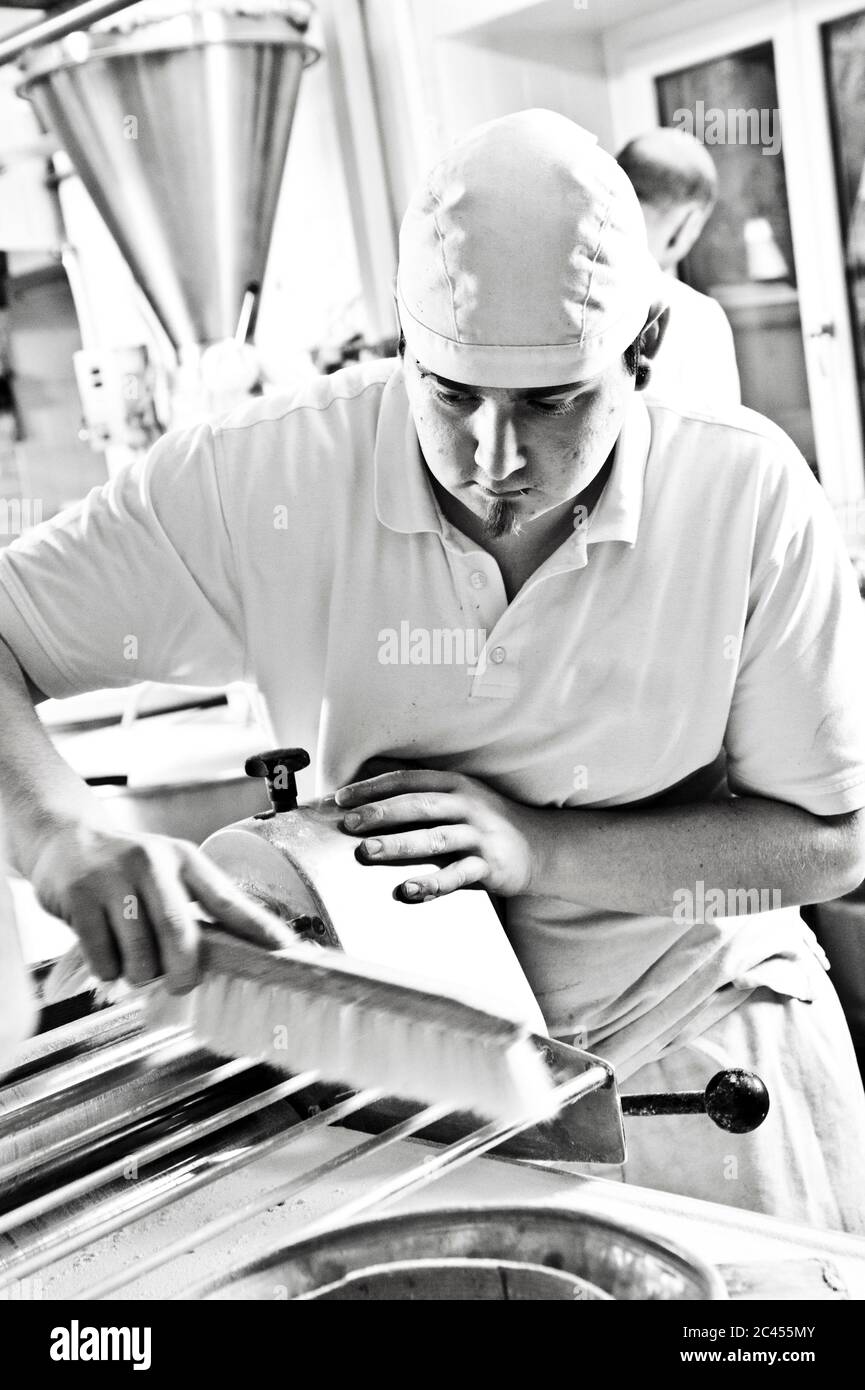 Baker working in basic bakery hi-res stock photography and images - Alamy