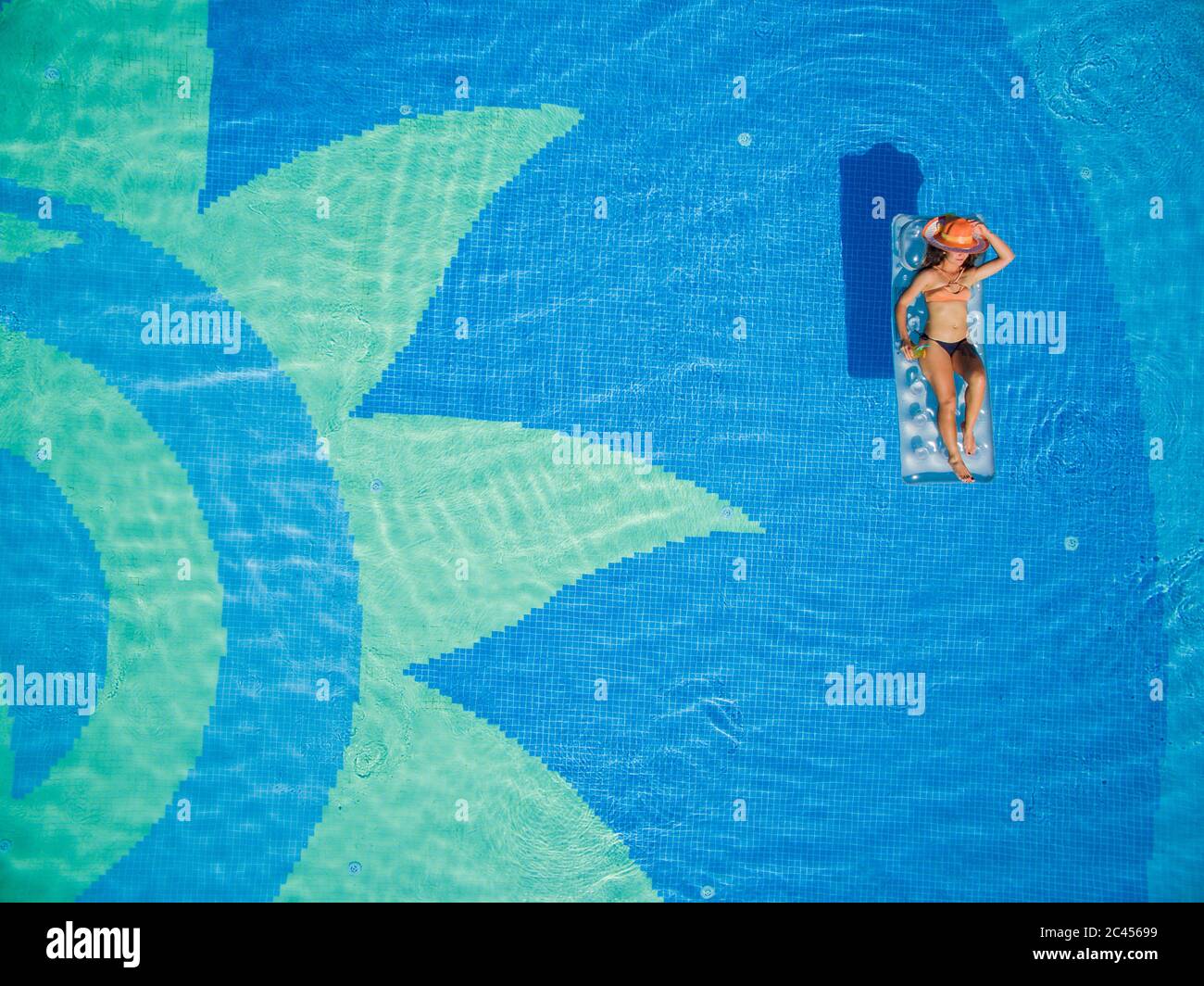 Young woman sunbath in pool Stock Photo - Alamy