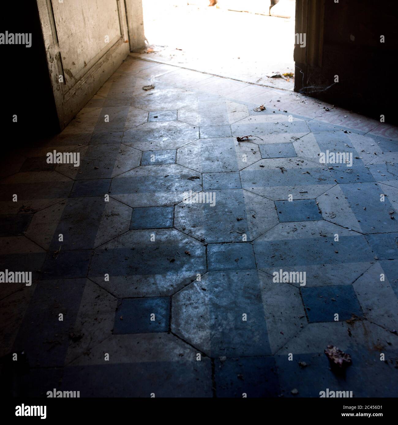Door opening into a tiled entrance hall in a old house Stock Photo - Alamy