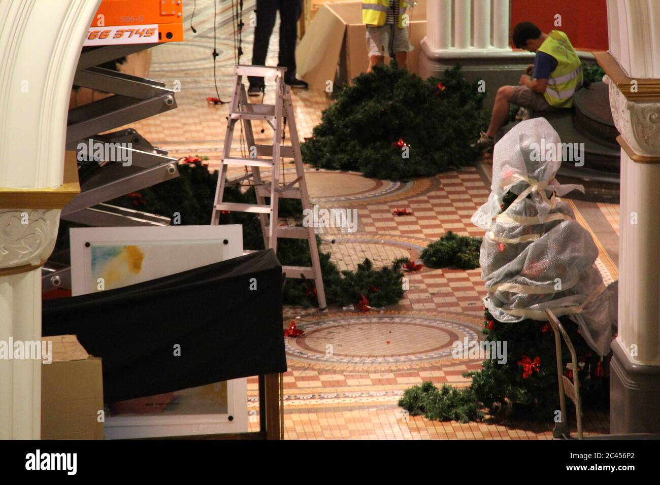 Workers dismantle the giant Christmas tree at the QVB in Sydney Stock ...