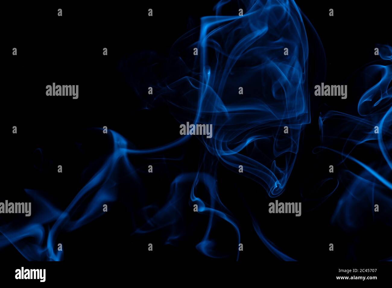 Shot of smoke with blue light effects isolated on a black background ...