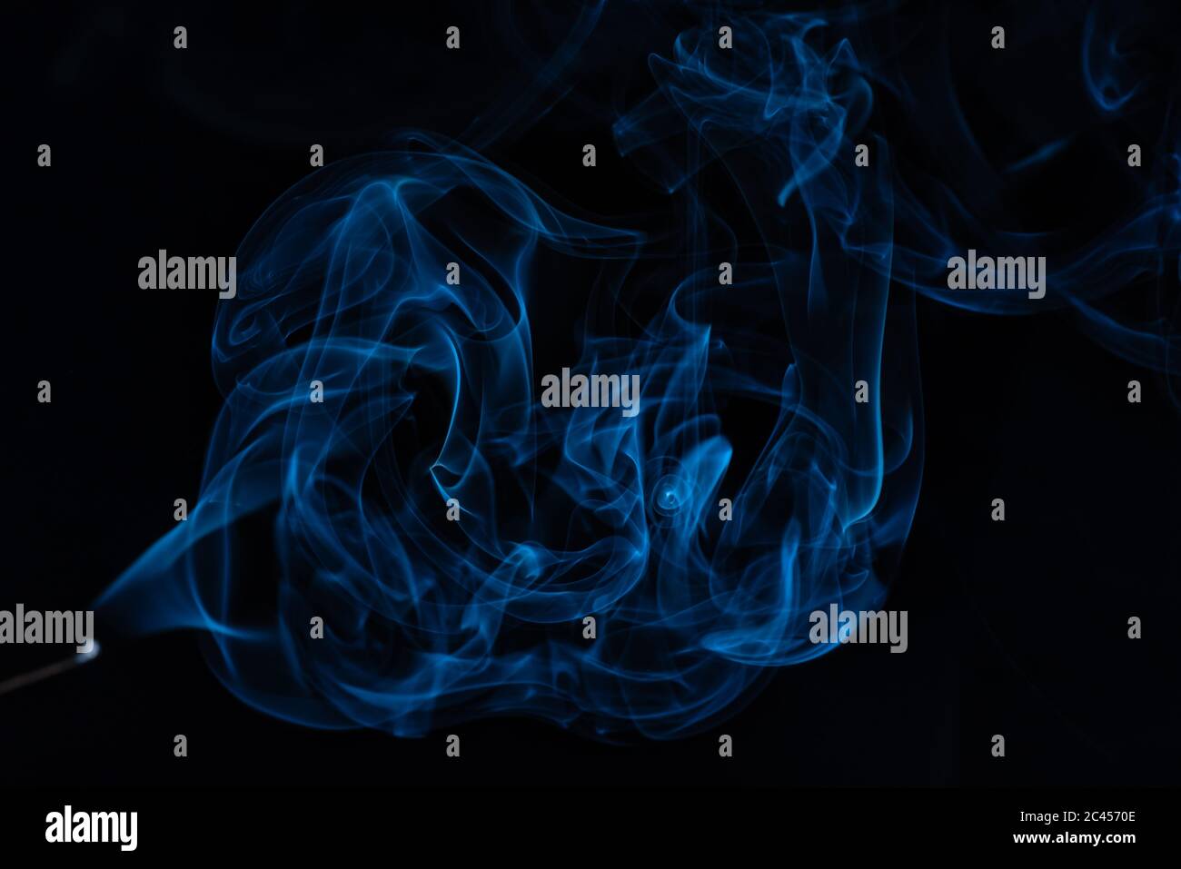 Shot of smoke with blue light effects isolated on a black background ...